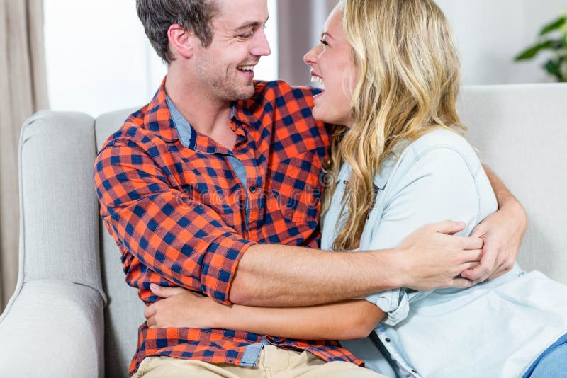 Couple Hugging on the Couch Stock Photo - Image of happy, clothing ...