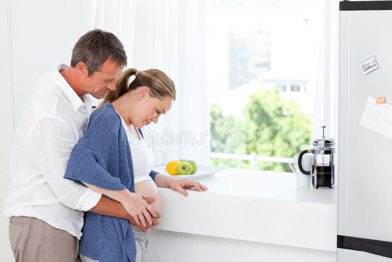 Couple Hugging in the Kitchen Stock Image - Image of parenting, posing ...