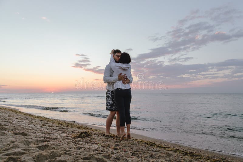 Couple Hugging Look at Sunset Above Sea Stock Image - Image of clouds ...