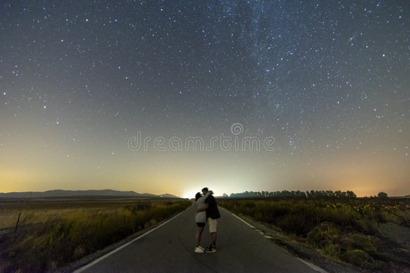 Couple Hugging in the Middle of the Road Under a Starry Night Sky ...