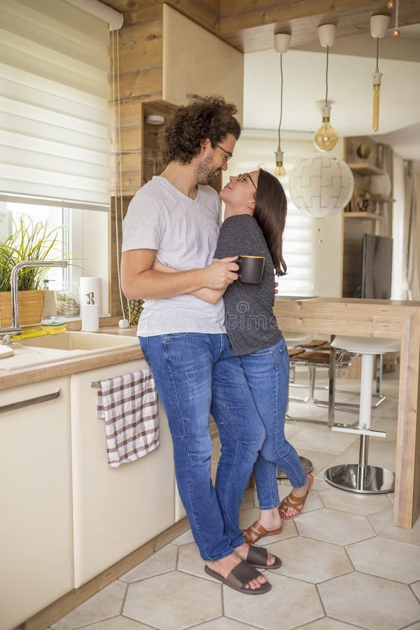 Couple Hugging, Relaxing and Drinking Morning Coffee at Home Stock ...