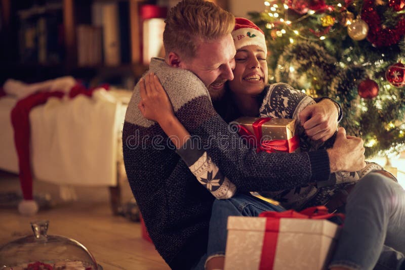 Couple Hugging by Christmas Tree Stock Photo - Image of girl, happy ...