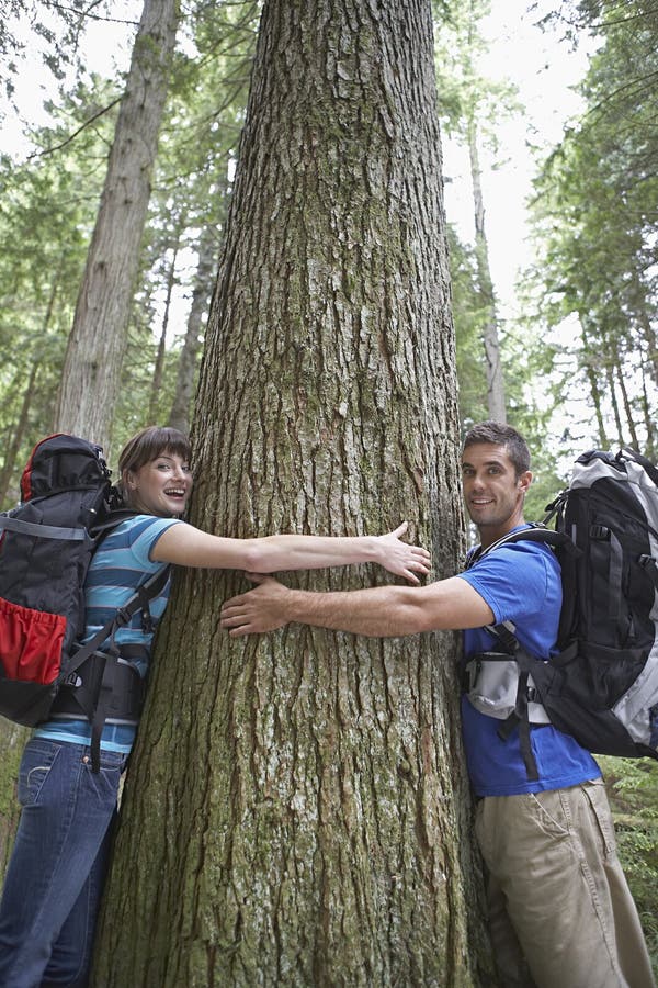 Couple Hugging Tree in Forest Stock Image - Image of side, hugging ...