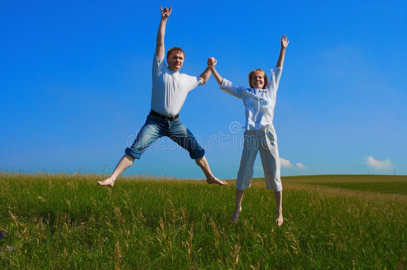 Couple Jumping In Field Picture. Image: 977039