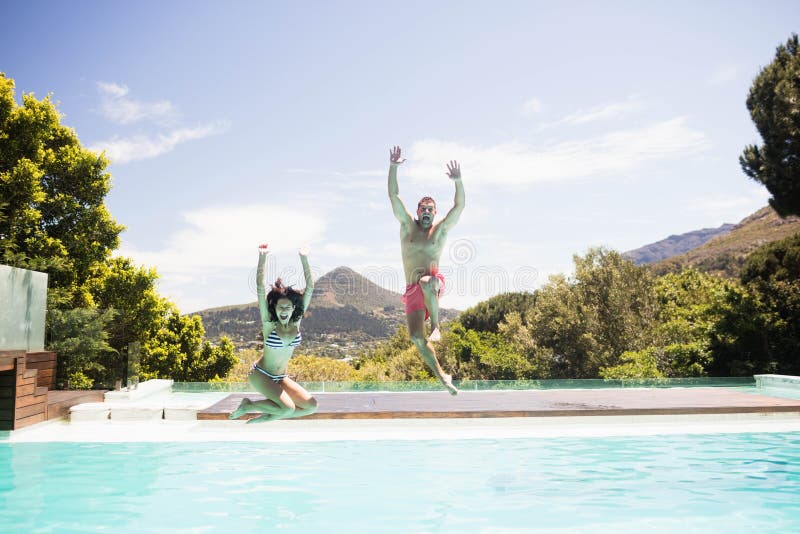Couple Jumping into Swimming Pool Stock Image - Image of excited ...