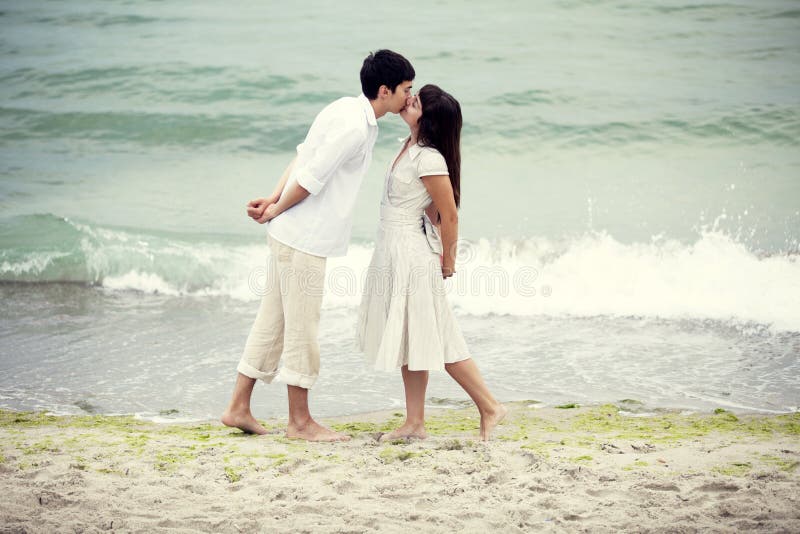 Couple Kissing at the Beach Stock Photo - Image of carefree, love: 25717618