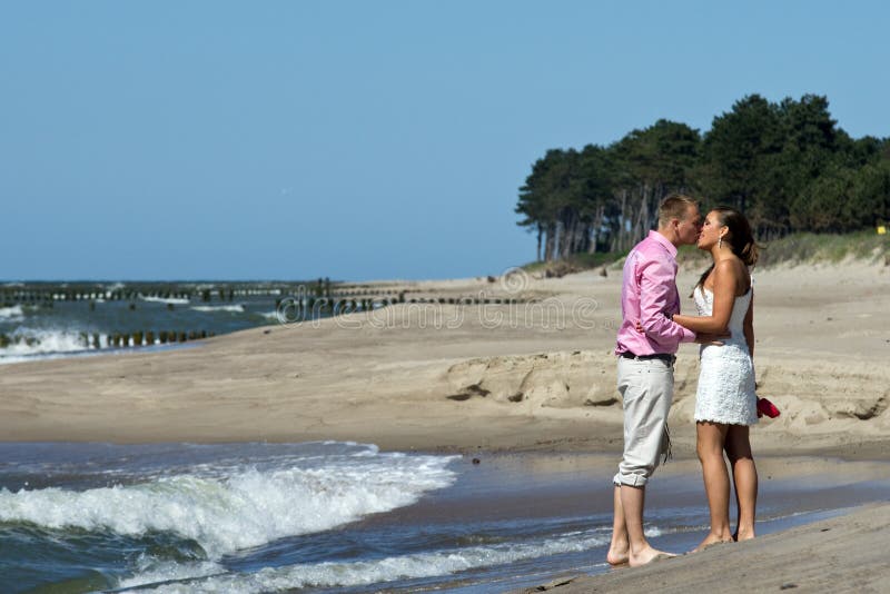Couple kissing on beach stock photo. Image of scenic - 28155964