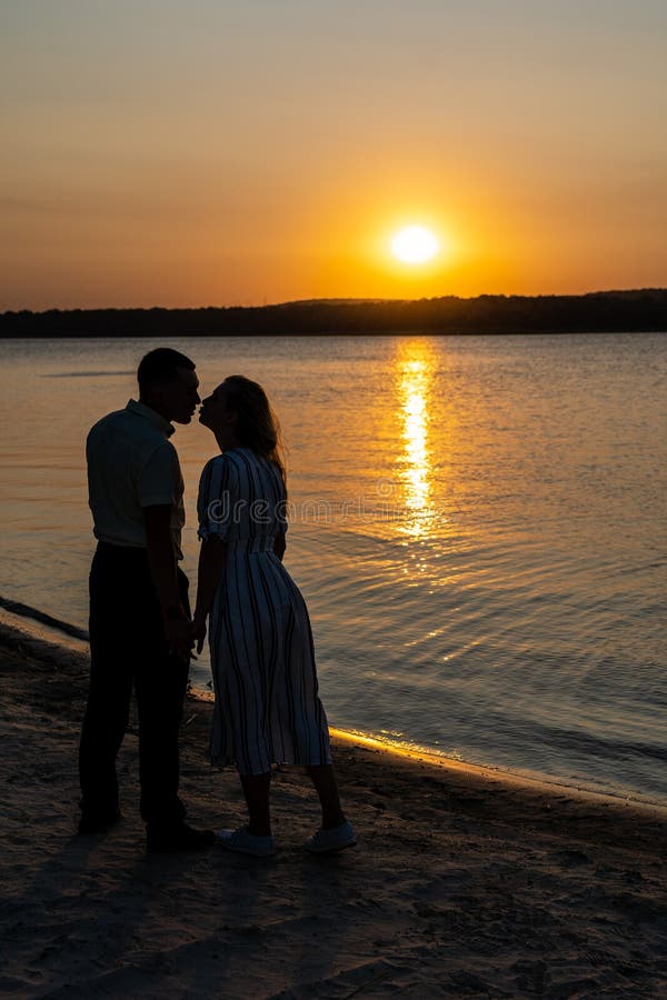 Couple Kissing on the Sunset on the Beach Stock Photo - Image of arms ...