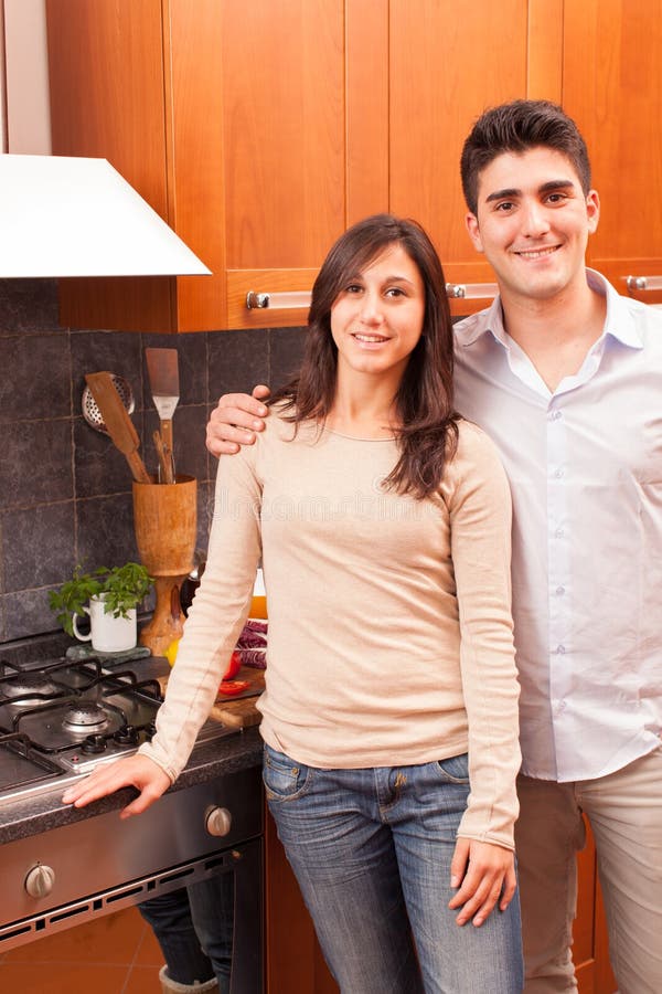 Couple in the Kitchen stock image. Image of embracing - 23128523