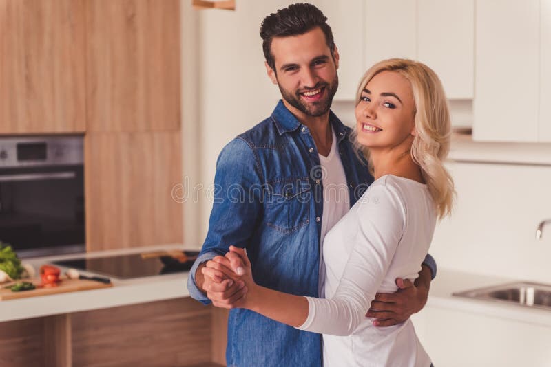 Couple in kitchen stock photo. Image of cuddle, family - 89787978