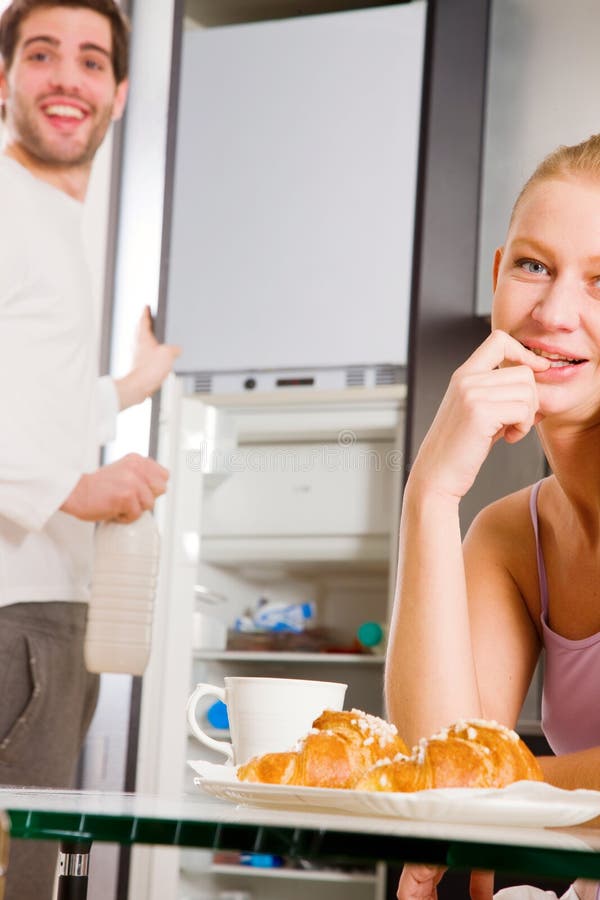 Couple in Kitchen Having Breakfast Stock Photo - Image of drink, finger ...