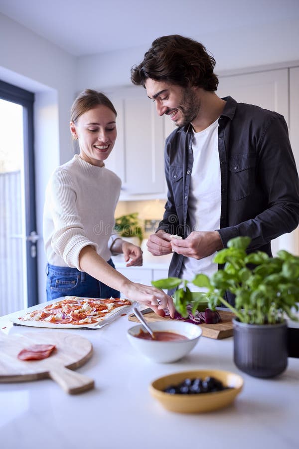 Couple in Kitchen at Home Making Homemade Pizza Together Stock Image ...