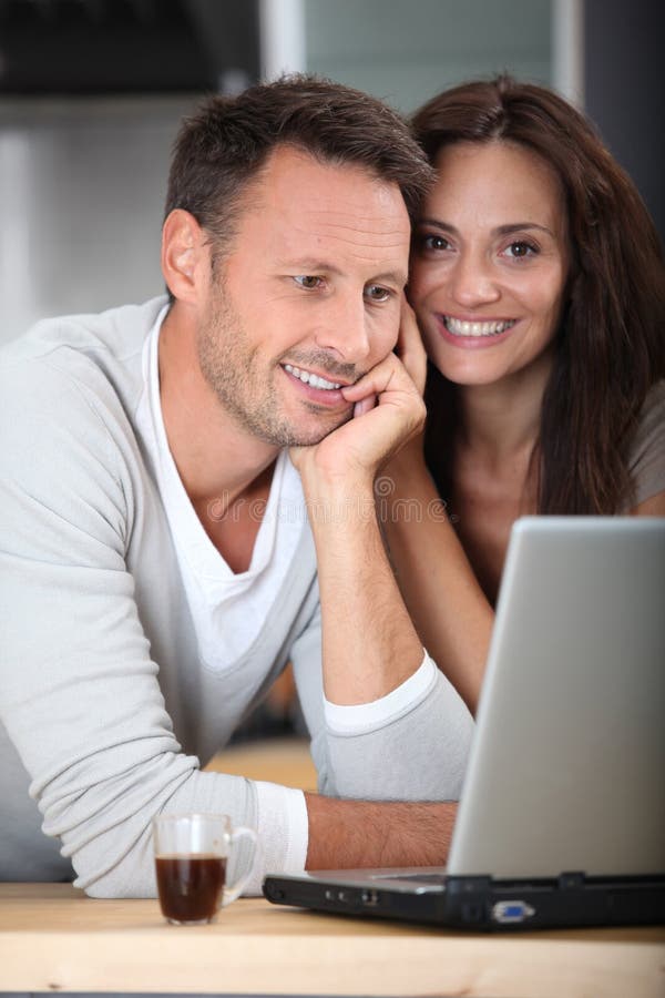 Couple in Kitchen with Laptop Computer Stock Photo - Image of video ...