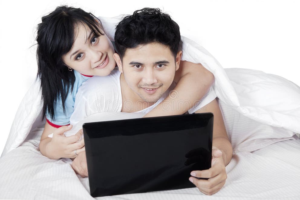 Couple with Laptop Cuddling on Bed Stock Image - Image of asian, female ...