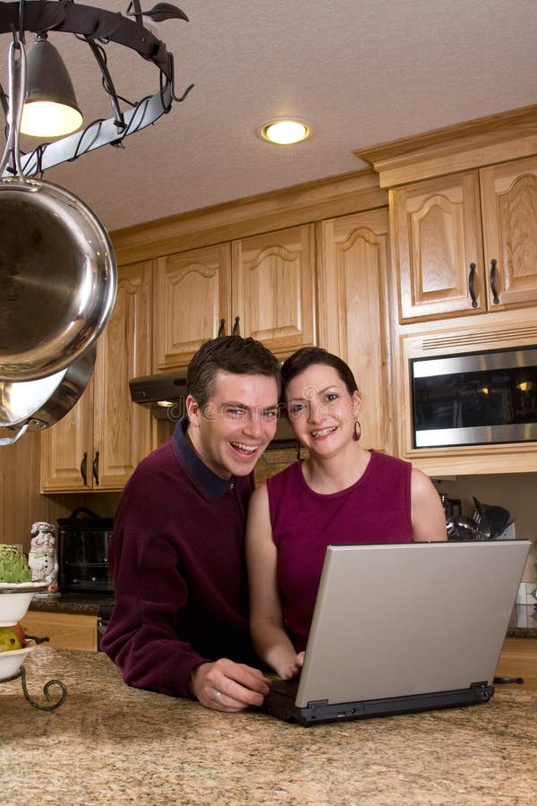 Couple with Laptop in Kitchen - Vertical Stock Image - Image of loving ...