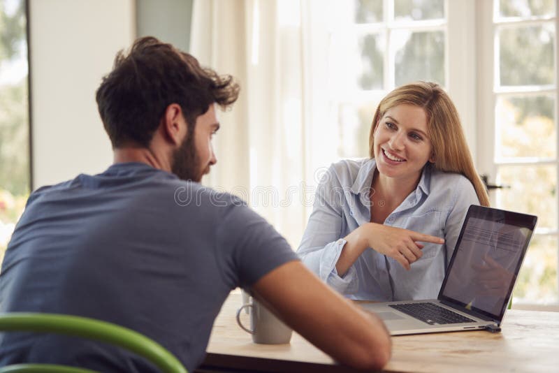 Couple with Laptop Sitting at Table Working from Home Together Stock ...
