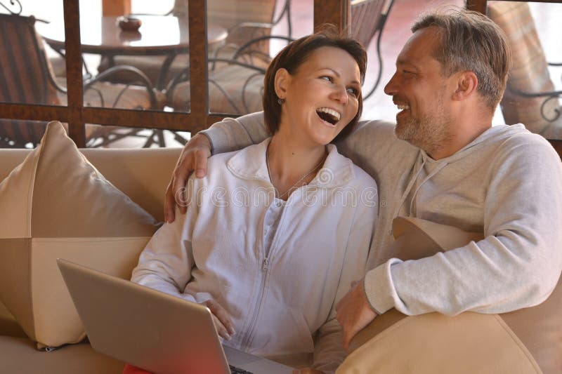 Couple with Laptop at Table Stock Photo - Image of healthy, woman: 55176354