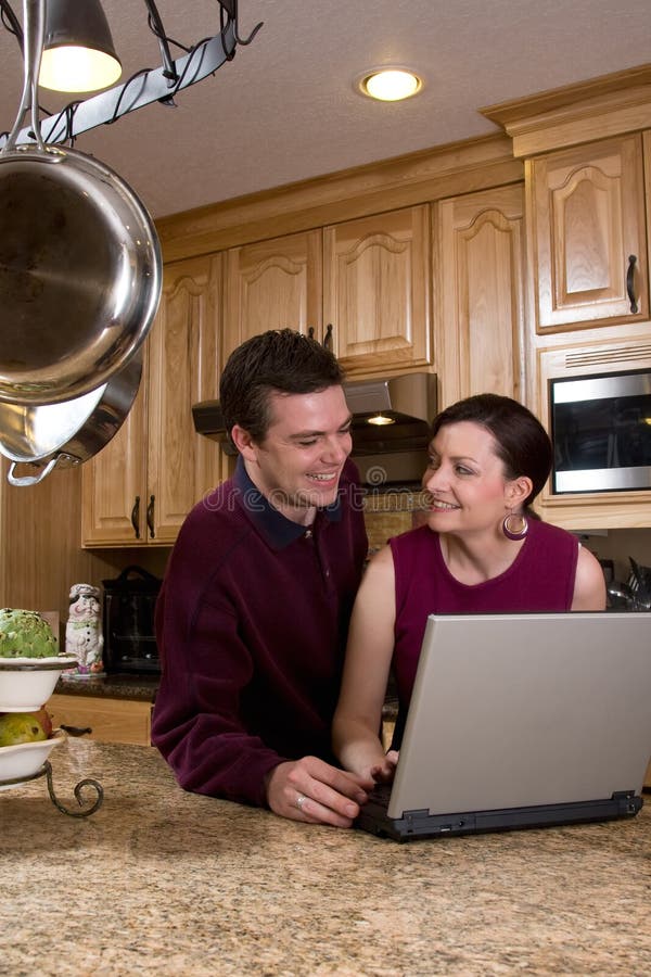 Couple looking at laptop. stock photo. Image of color - 2051766