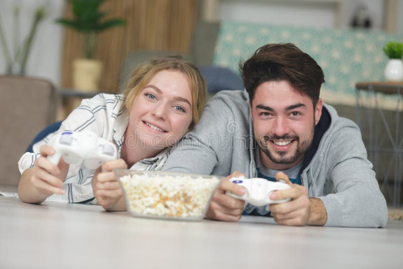 Couple Laying on Floor Playing Console Game Stock Photo - Image of ...