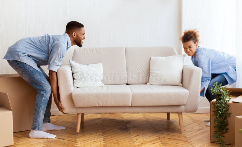 Couple Lifting Sofa Standing in Empty Room after Moving House Stock ...