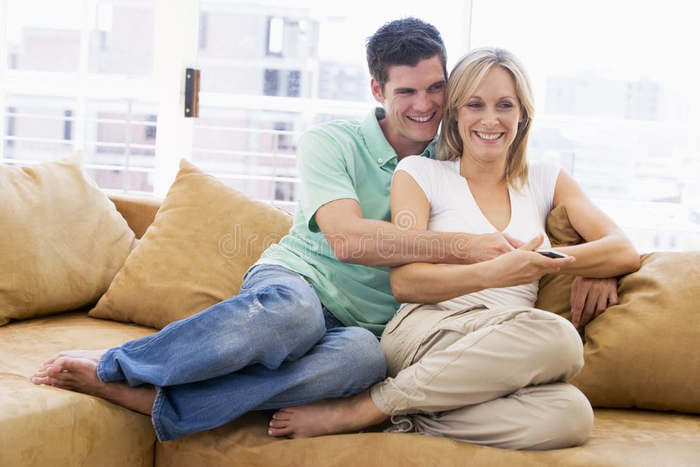 Couple in Living Room with Remote Control Stock Photo - Image of ...