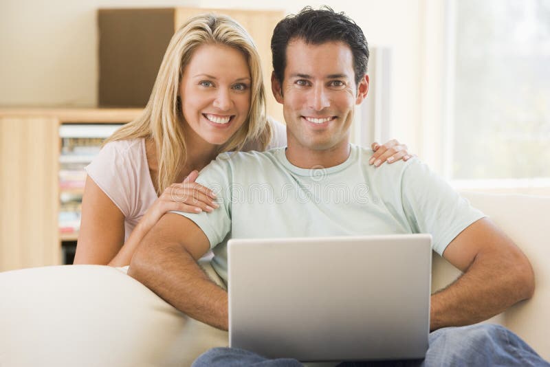 Couple in Living Room Using Laptop Smiling Stock Image - Image of adult ...