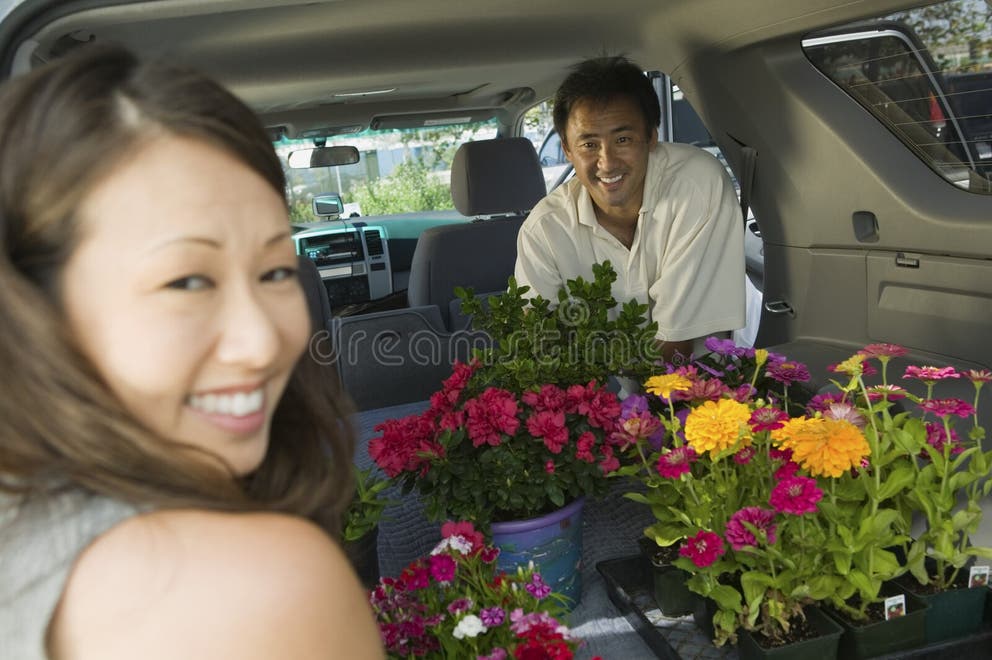 Couple Loading Flowers into Back of SUV Portrait Stock Photo - Image of ...