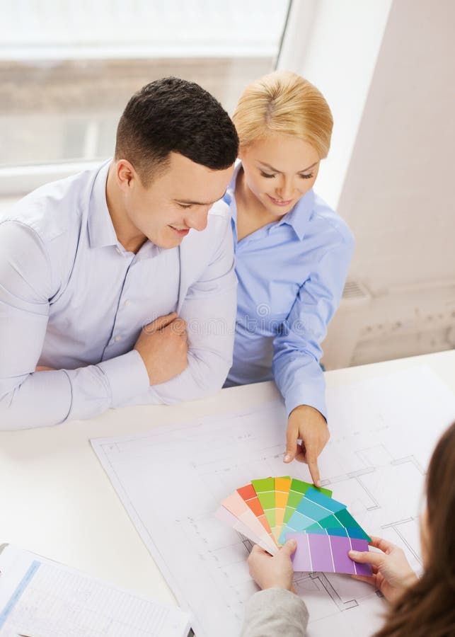 Couple Looking at Blueprint and Color Samples Stock Image - Image of ...
