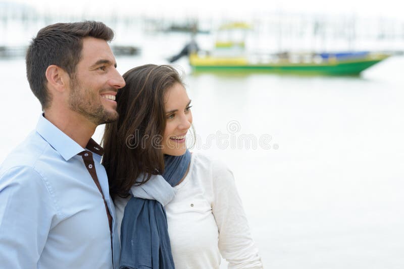 Couple Looking into Distance by Harbour Stock Photo - Image of flirt ...
