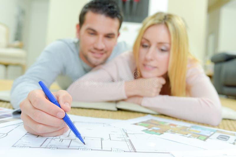 Couple Looking at House Plans Stock Image - Image of blueprints, front ...