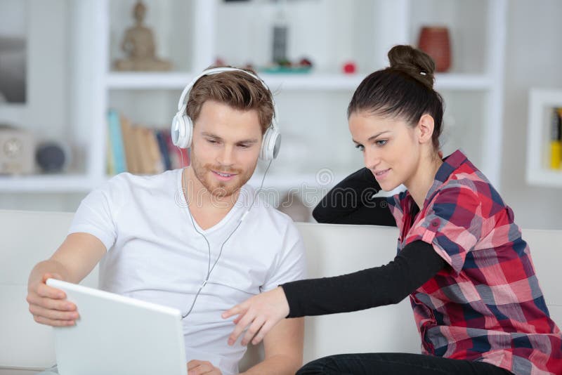 Couple looking at laptop stock photo. Image of relaxing - 203840092