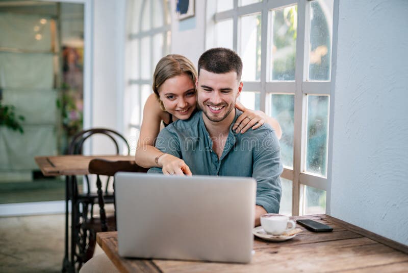Couple Looking at Laptop Computer Together at Home. the Concept of ...
