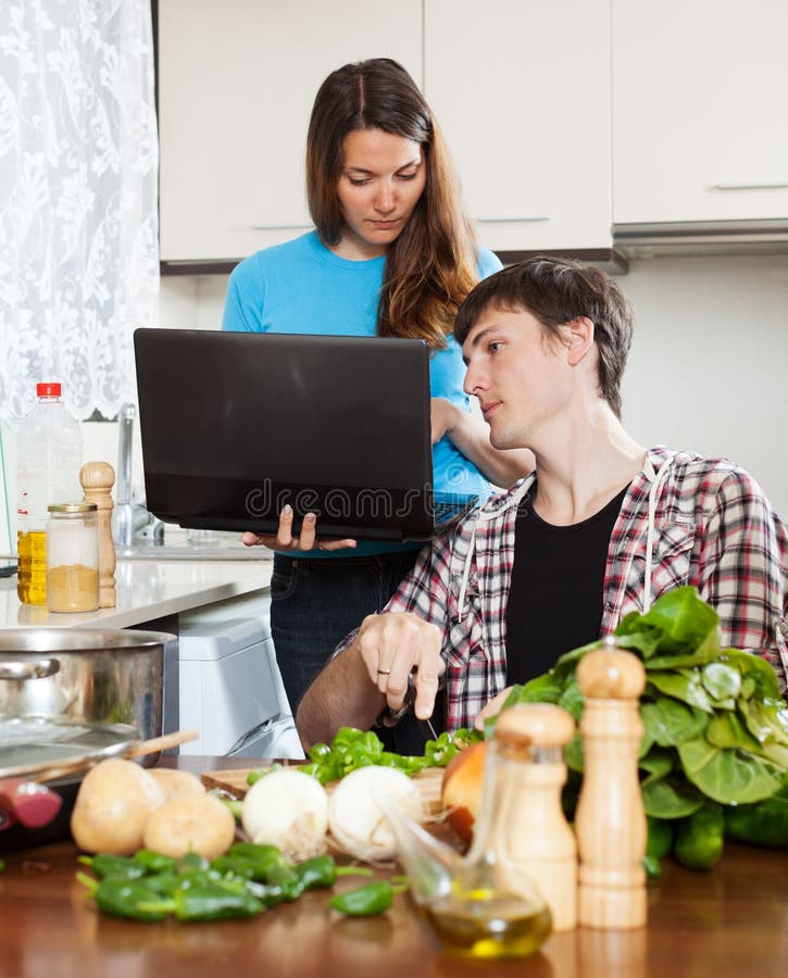 Couple Looking at Notebook during Cooking Food Stock Image - Image of ...
