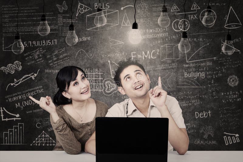 Couple Looking at Solution Light Bulbs in Class Stock Photo - Image of ...