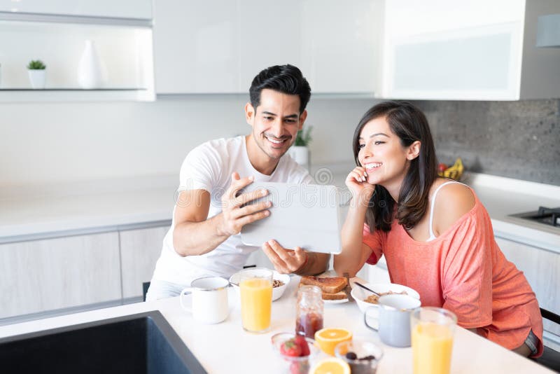 Couple Looking at Tablet Computer during Breakfast Stock Photo - Image ...
