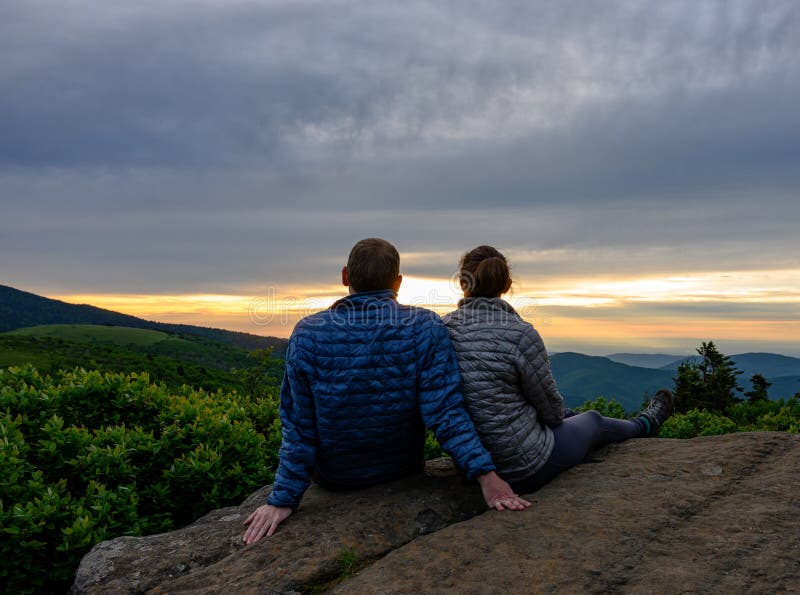 Couple Looks Out Over Sunset Falling on Blue Ridge Stock Photo - Image ...