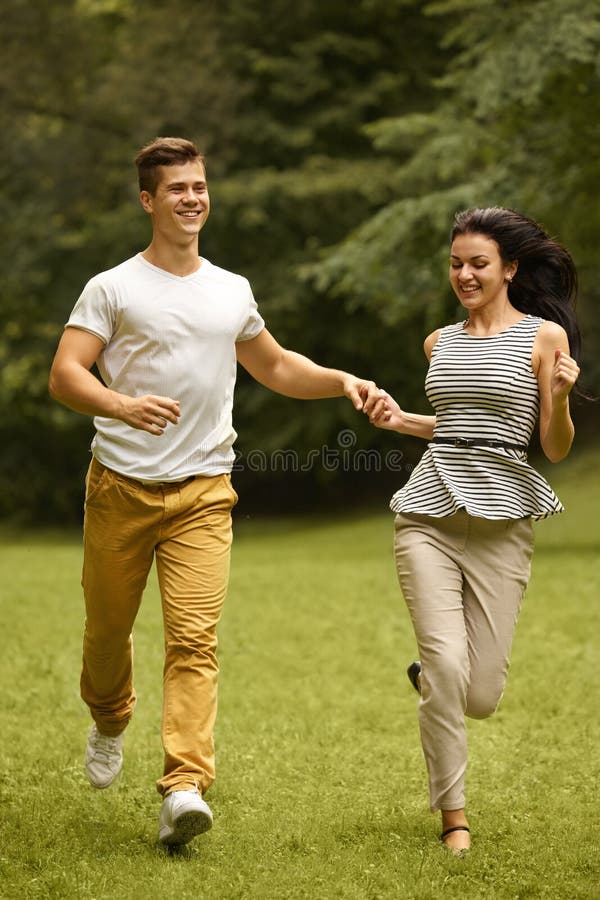 Couple in Love. Happy Couple Running in the Park Stock Image - Image of ...
