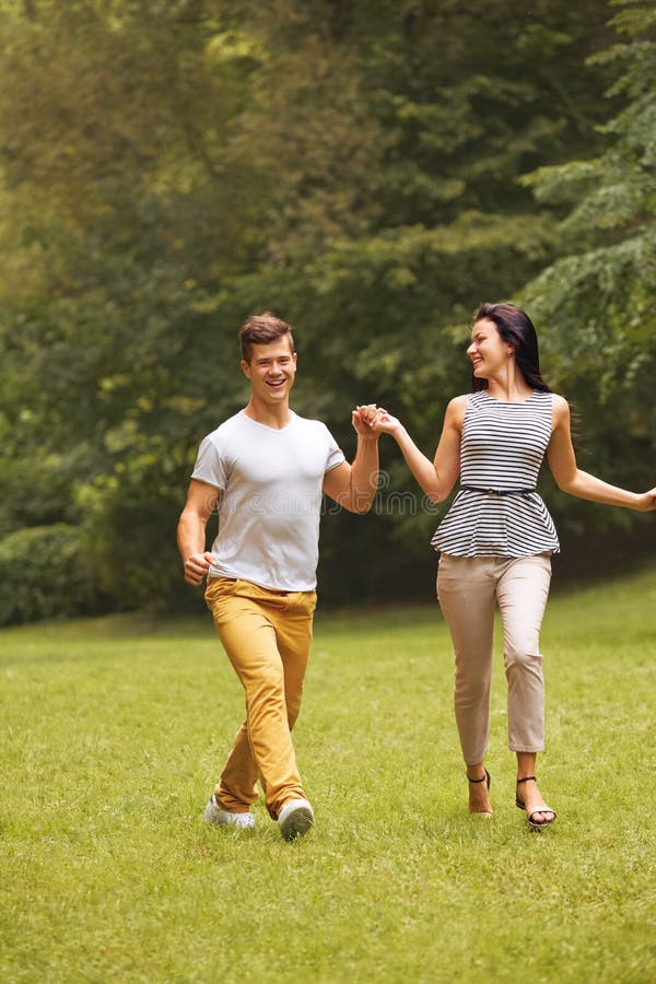 Couple in Love. Happy Couple Running in the Park Stock Photo - Image of ...