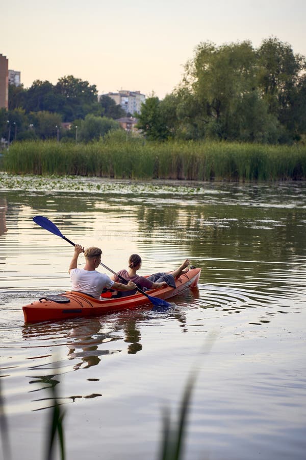 The Couple in Love Kayaking on the River at Sunset Stock Photo - Image ...