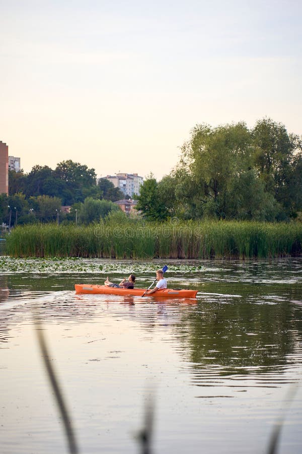 The Couple in Love Kayaking on the River at Sunset Stock Photo - Image ...