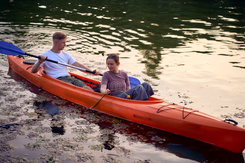 The Couple in Love Kayaking on the River at Sunset Stock Photo - Image ...