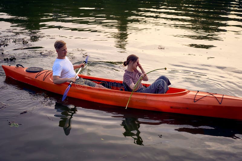 The Couple in Love Kayaking on the River at Sunset Stock Photo - Image ...