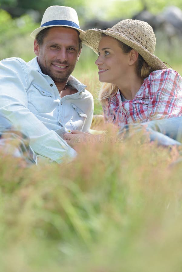 Couple in Love Laying on Grass and Looking at Camera Stock Photo ...