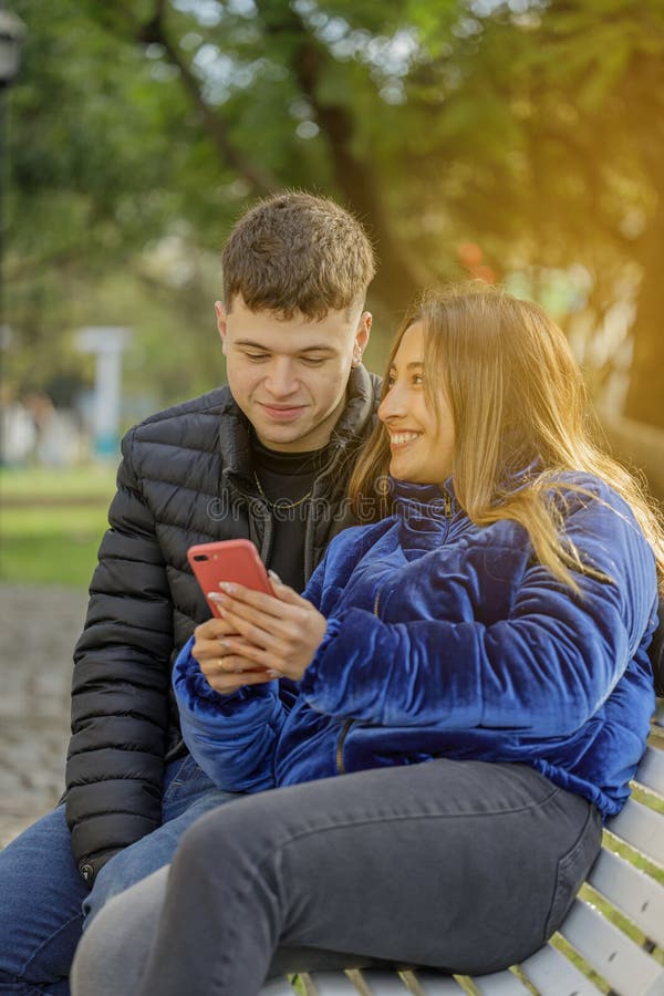 Couple in Love Sitting on a Bench in a Public Park Stock Photo - Image ...