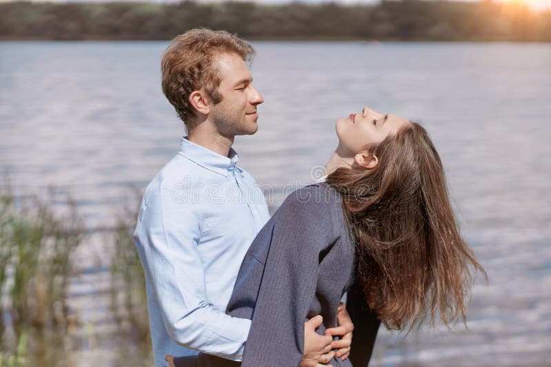 Couple in Love Standing Together on the Shore of the Lake . Stock Image ...