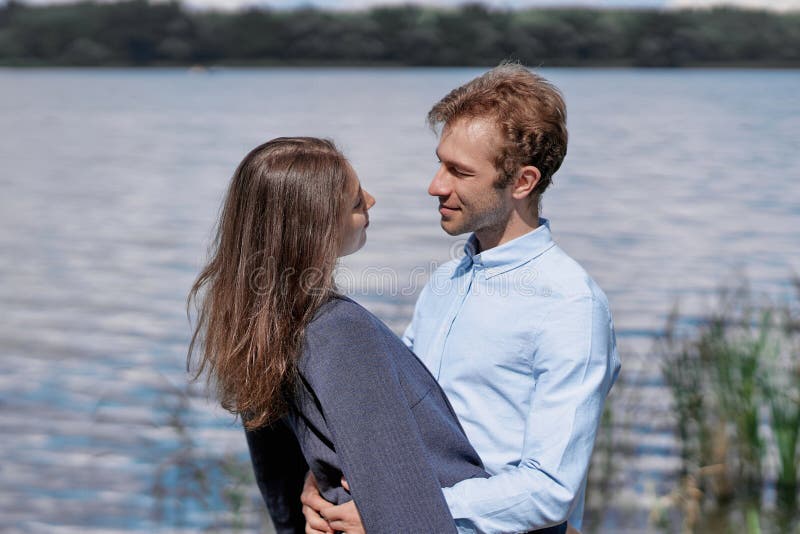 Couple in Love Standing Together on the Shore of the Lake . Stock Image ...