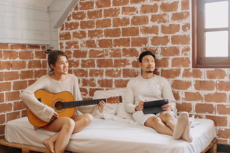 Couple Lover Concentrate on Create a Song with Guitar and Tablet. Stock ...