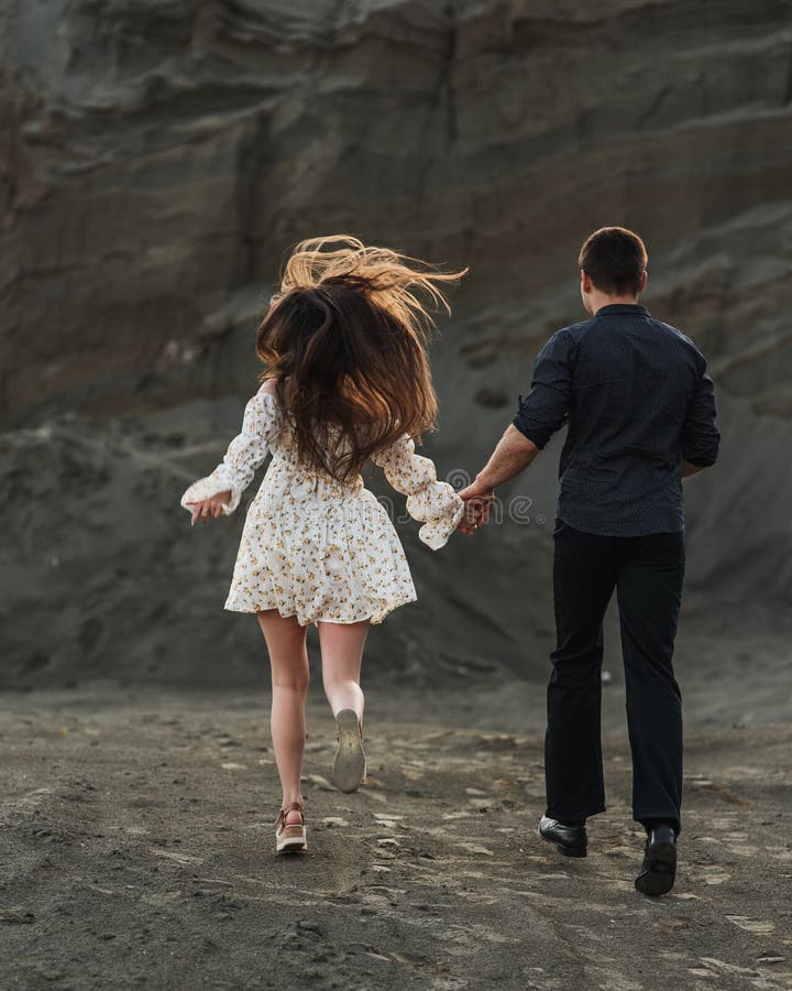 Couple of Lovers Holding Hands and Running Away Stock Image - Image of ...