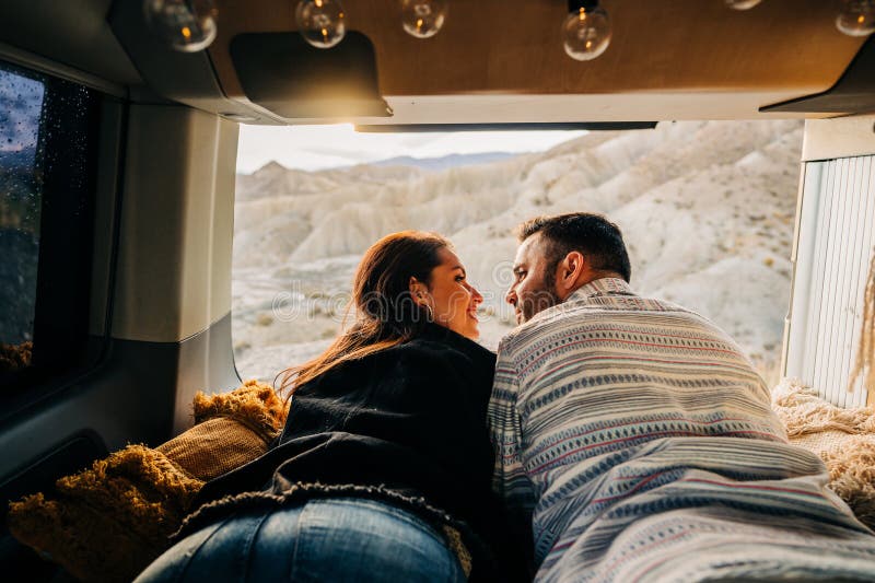 Couple Lying Inside Camper Van Looking at Desert Landscape Stock Image ...