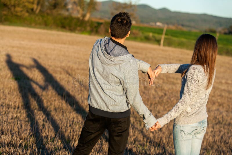 Couple Making Love Sign with Arms Outdoors. Stock Photo - Image of male ...